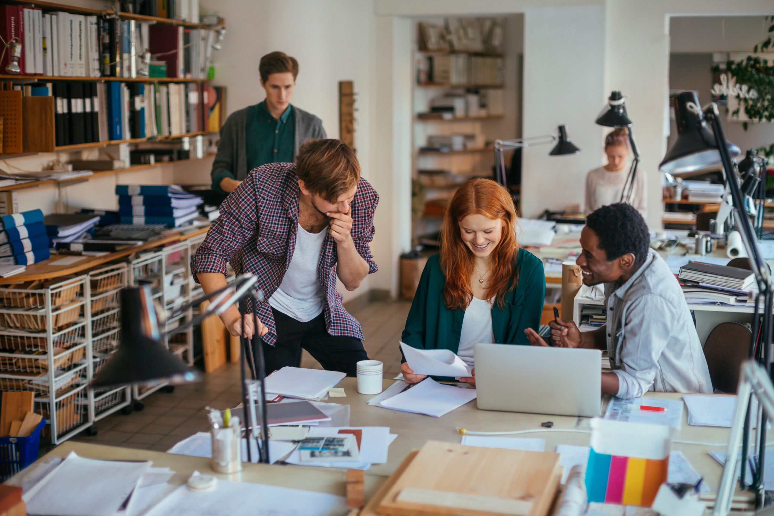 Employees collaborating in creative office environment